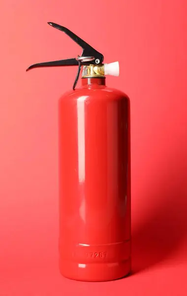 One fire extinguisher on red background. Safety equipment - Stock Image ...