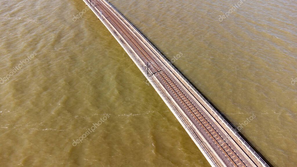 Aerial view of an amazing travel train parked on a floating railway ...