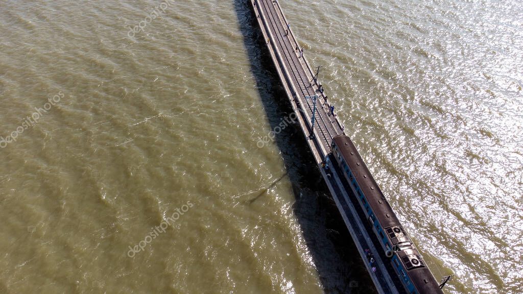 Aerial view of an amazing travel train parked on a floating railway ...