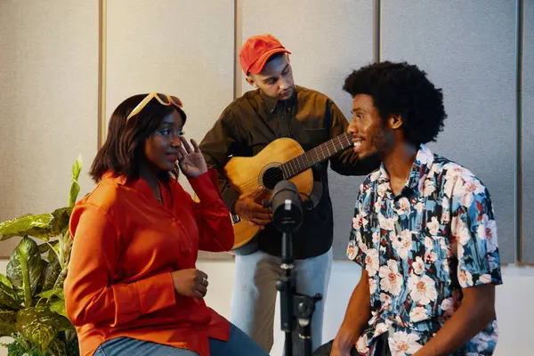 Music group rehearsing together in recording studio - Stock Image ...