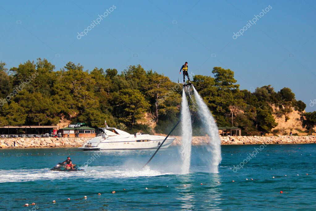 Kemer, Turkey - January 8, 2023: Tourists playing flyboard, a ...