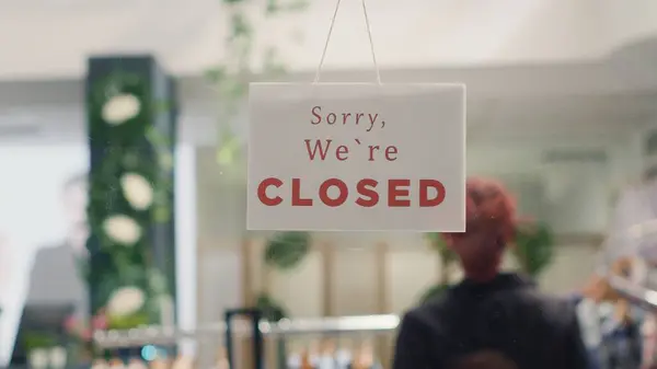 Worker closing down store in order to do restocking in elegant high end ...