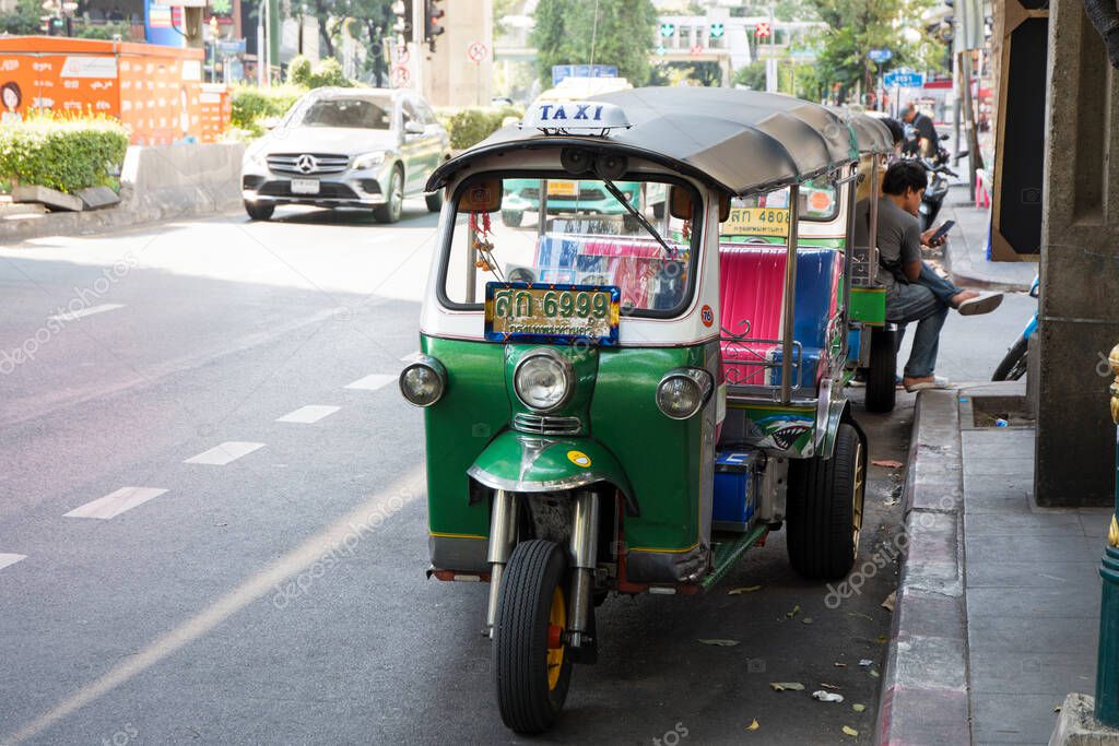 Bangkok, Thailand- 13 Feb, 2023: Traditional tuk-tuk on the road in Bangkok. Tuk tuks are ...