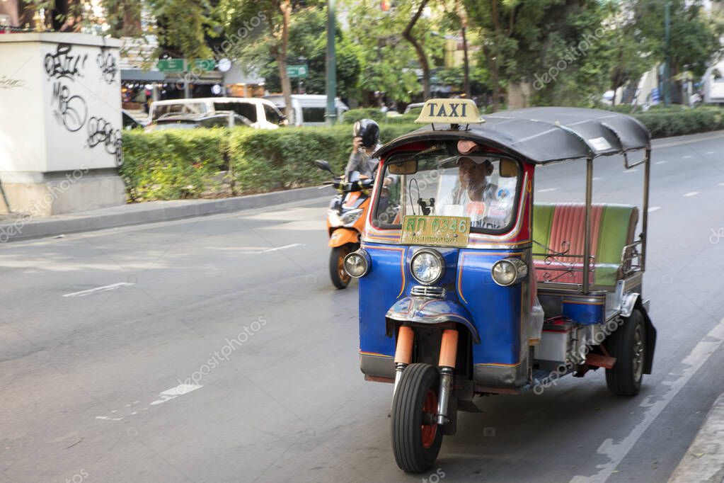 Bangkok, Thailand- 13 Feb, 2023: Traditional tuk-tuk on the road in Bangkok. Tuk tuks are ...