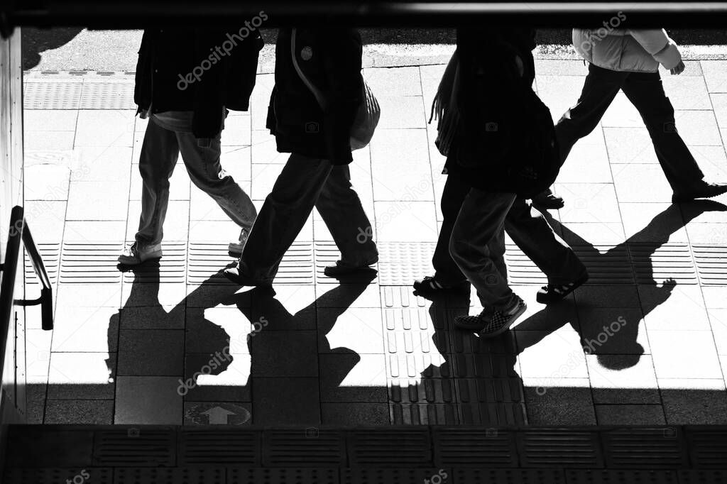 An abstract representation of passers-by in the station area. An ...