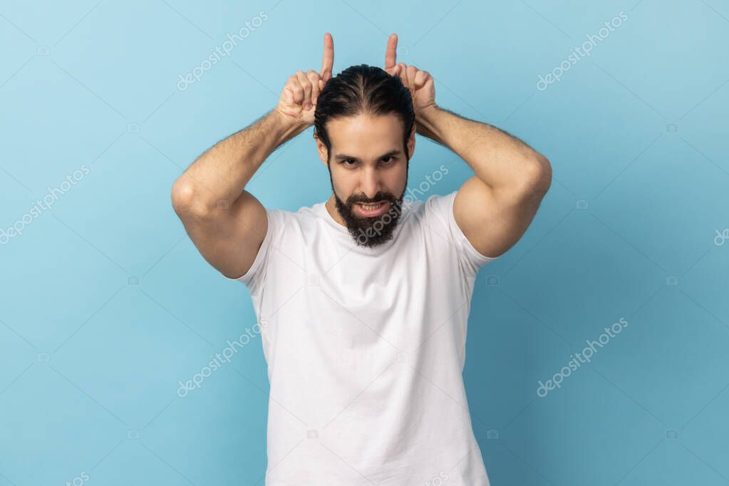 Portrait of aggressive bully man with beard wearing white T-shirt ...