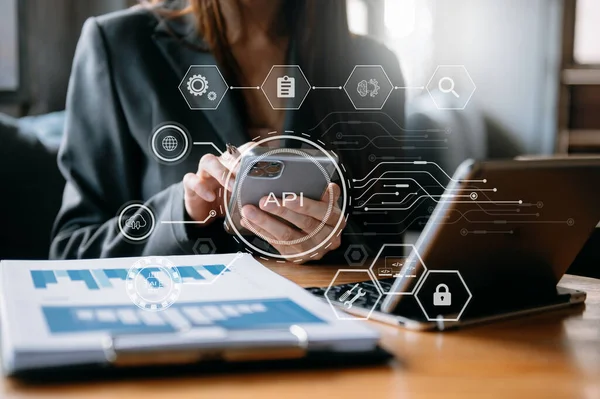 API Application Programming Interface, woman using tablet and smartphone with virtual screen API ...