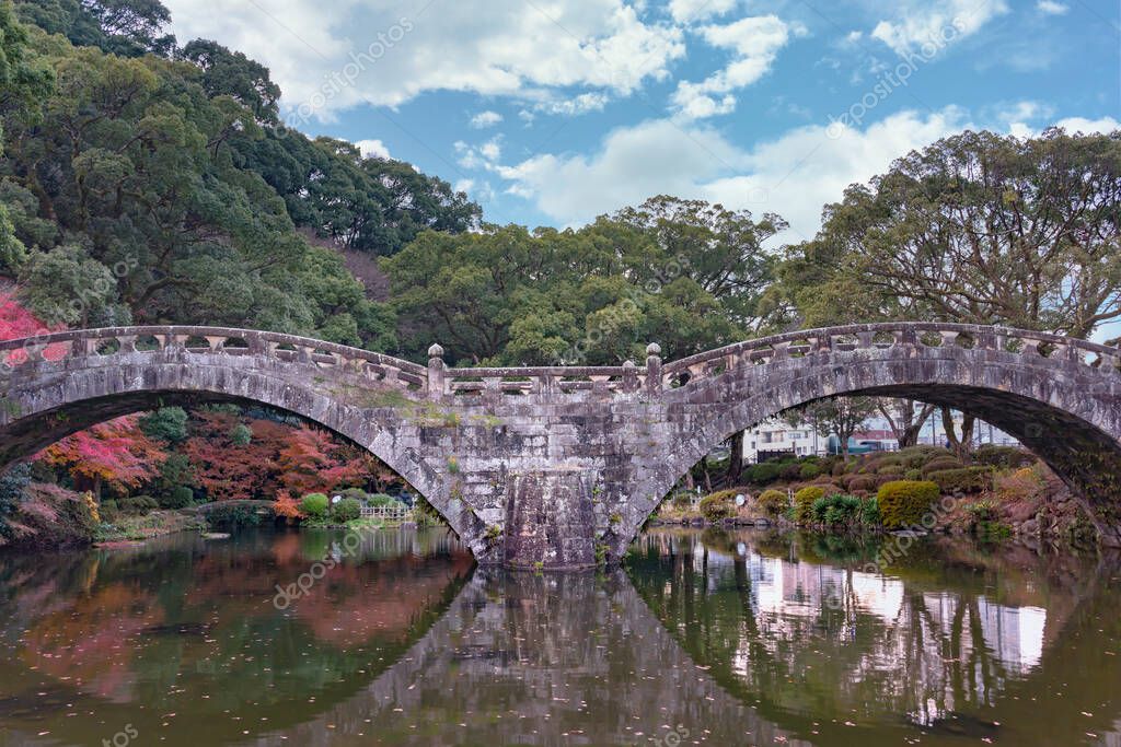 nagasaki, kyushu - December 10, 2022: The Meganebashi or Spectacles Stone Bridge reflecting its ...