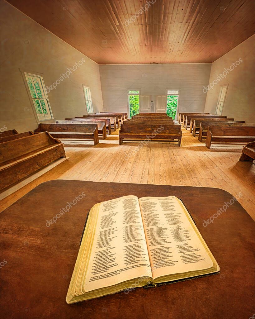 A vertical image of a pulpit top with an open Bible sitting on it, with ...