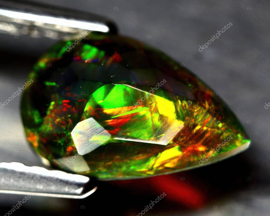 Natural gemstone noble opal on a black background 2024