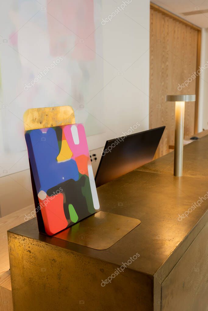 abstract painting at reception desk with computer monitor 2023