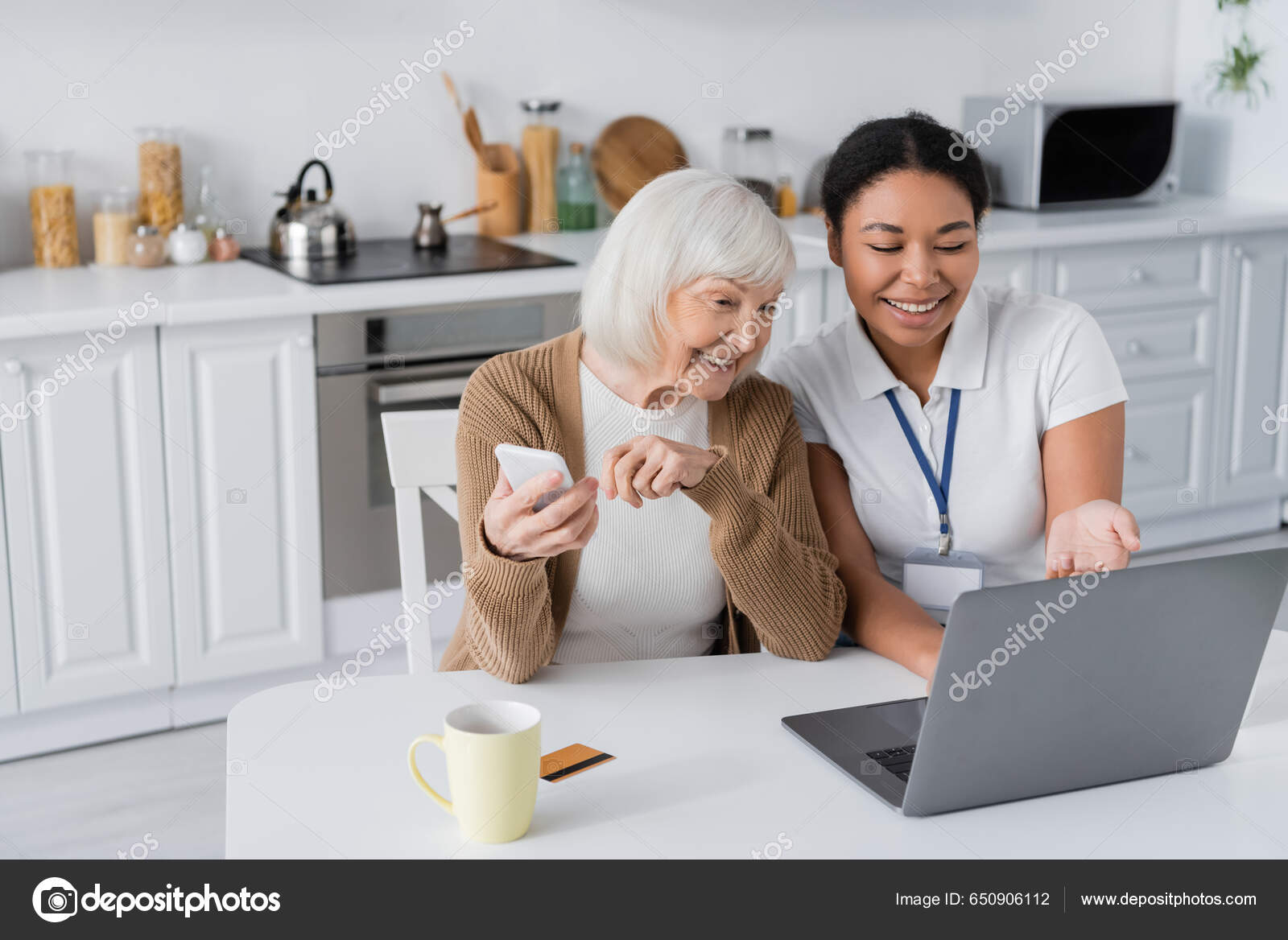 Happy Multiracial Social Worker Using Laptop Retired Woman Smartphone ...
