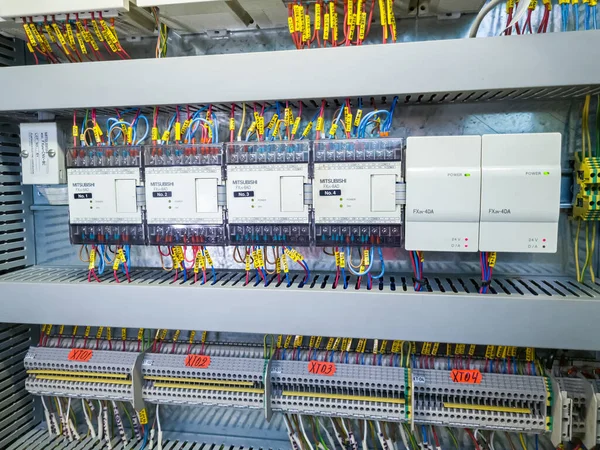 Mitsubishi PLC modules in a row in electrical cabinet of automation control system on industrial ...