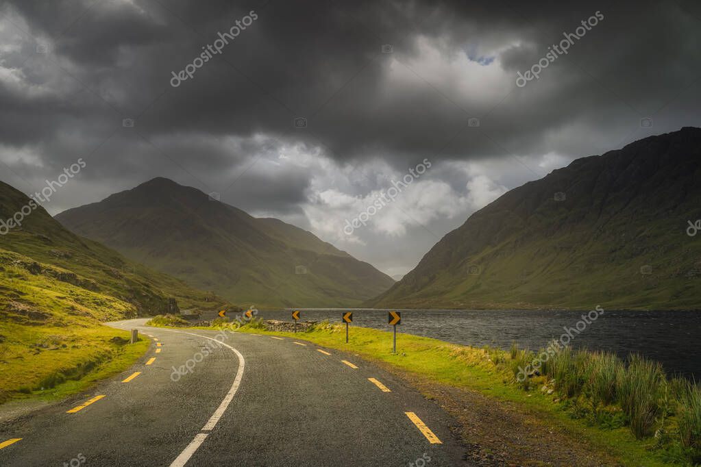 Road leading trough Doolough Valley beside lake and between Glenummera ...
