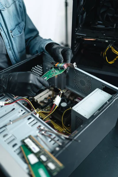 Close up of man hands wearing gloves repairing desktop computer. Pc ...