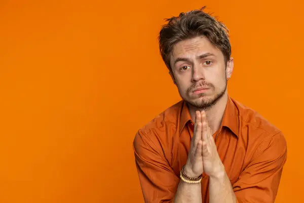 Please, God help. Caucasian man praying looking at camera and making ...
