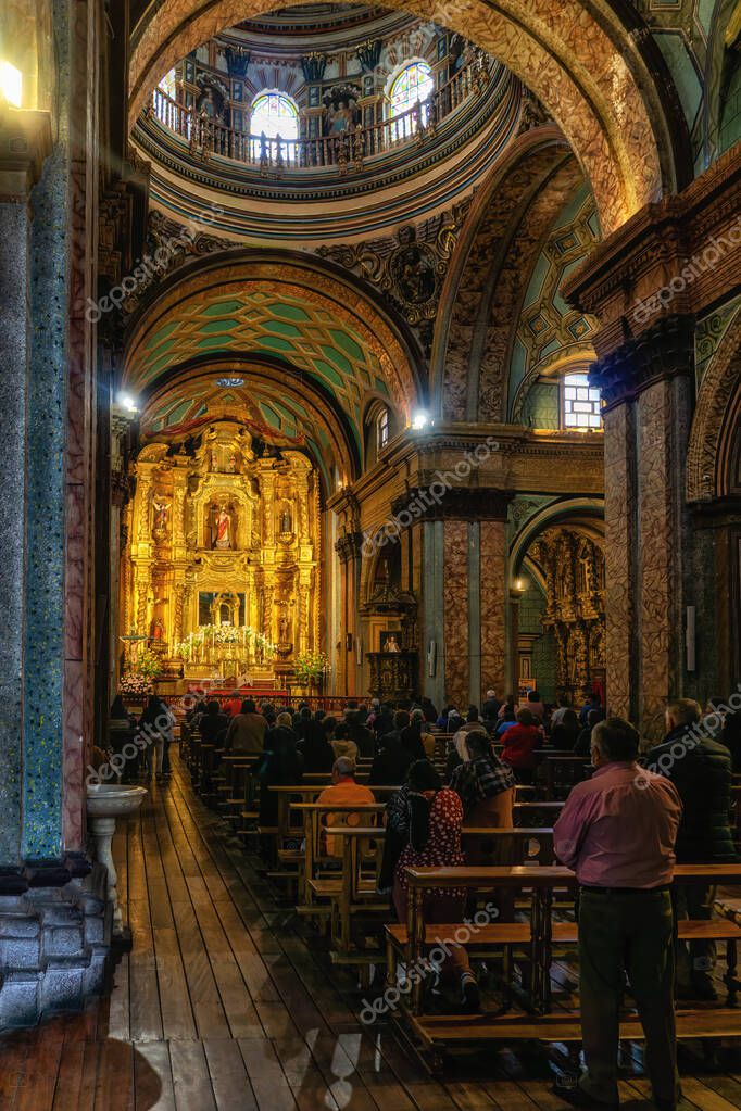 Quito, Ecuador - 24 November 2022: People praying in the church of El Sagrario in the historic ...