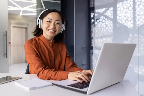 Young successful female programmer at workplace inside office working ...