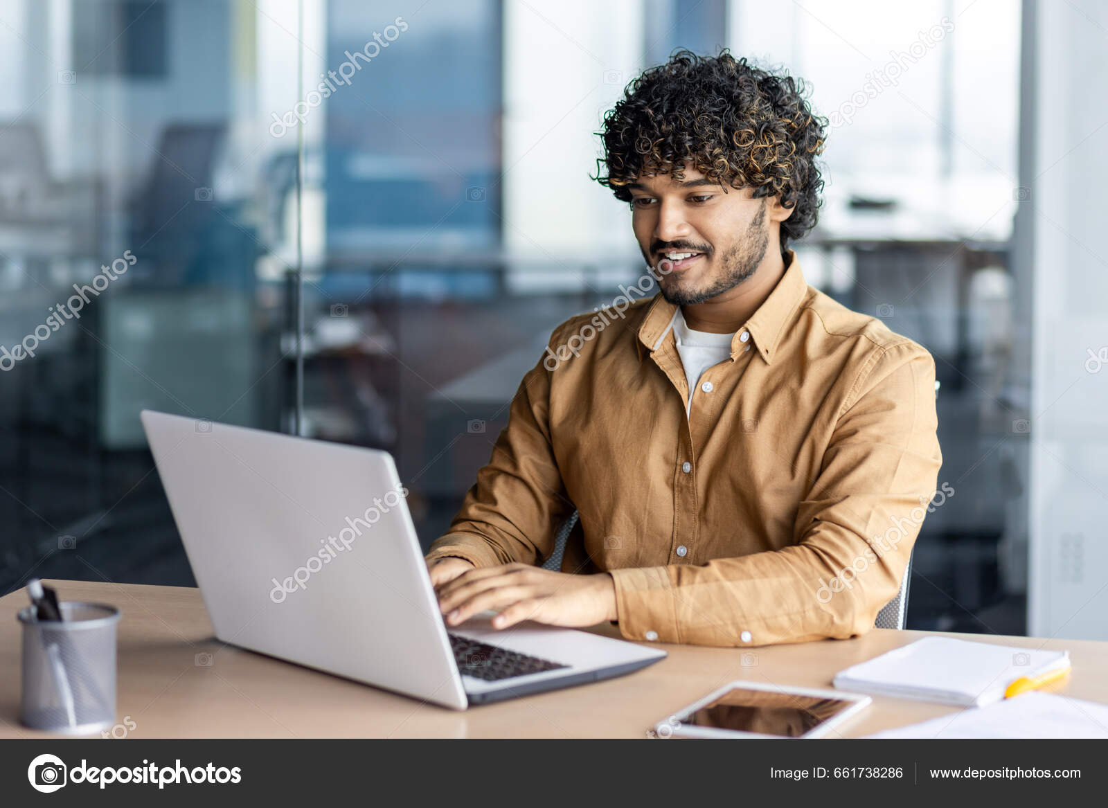Happy Office Worker At Desk