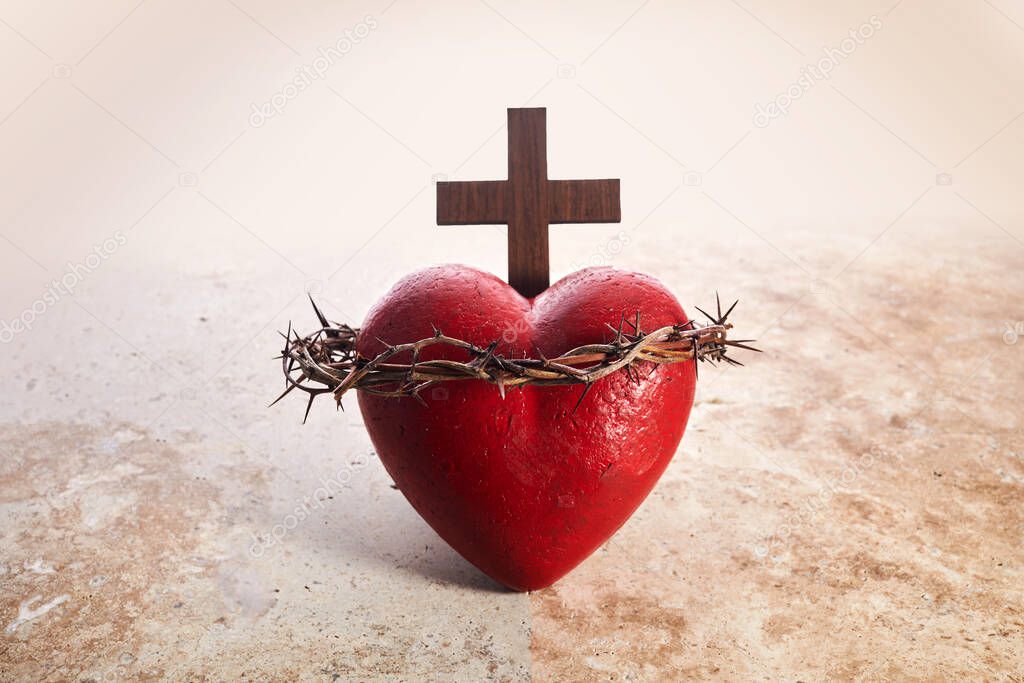 Sacred Heart of Jesus, surrounded by a crown of thorns and with wooden cross. 2024