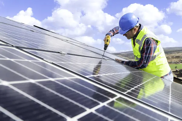 man in protective helmet and protective suit working on solar power ...