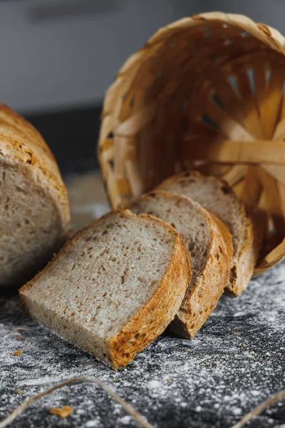 Slices of whole grain rye fresh bread on a dark background close up ...