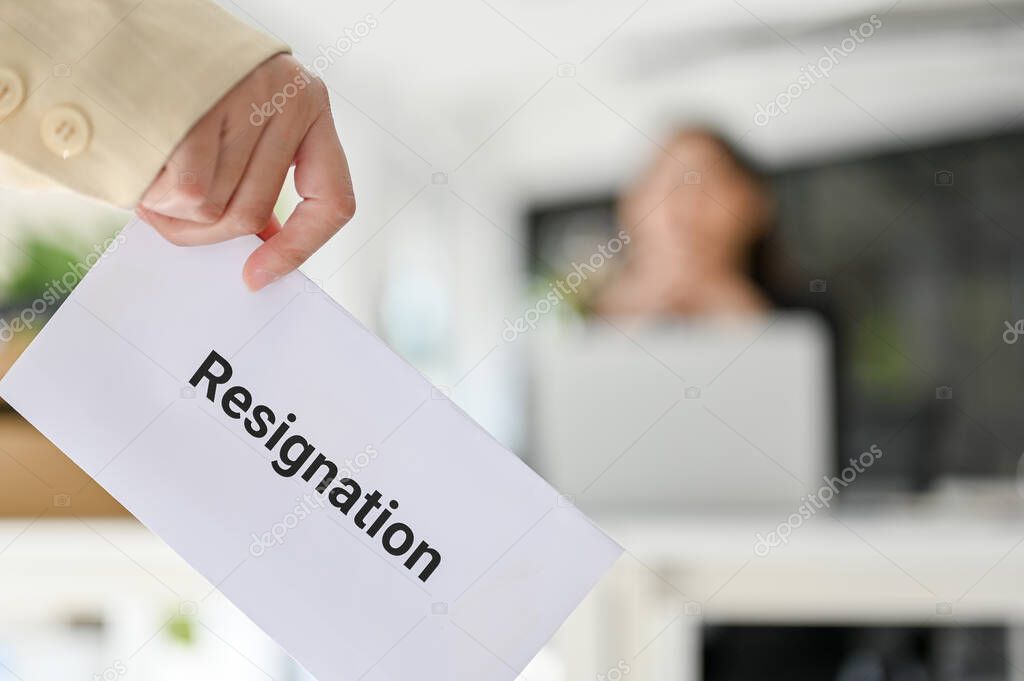 close-up image of a female office worker walking through her boss in the office with her ...