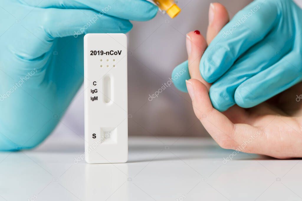 Doctor taking patient blood from finger for quick covid test. Covid ...