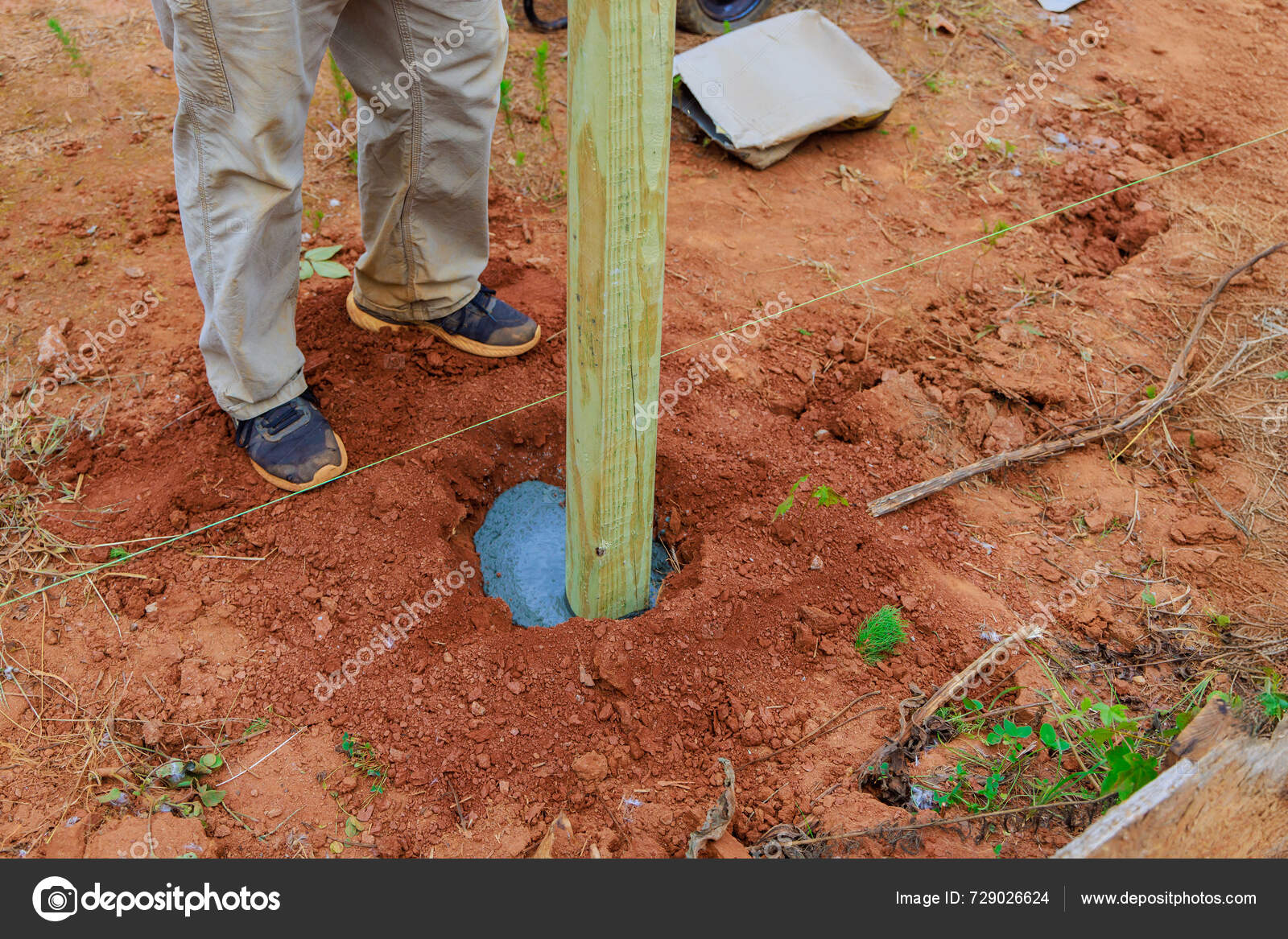 Concrete Pouring Newly Installed Timber Fencing Wood Fence Posts ...