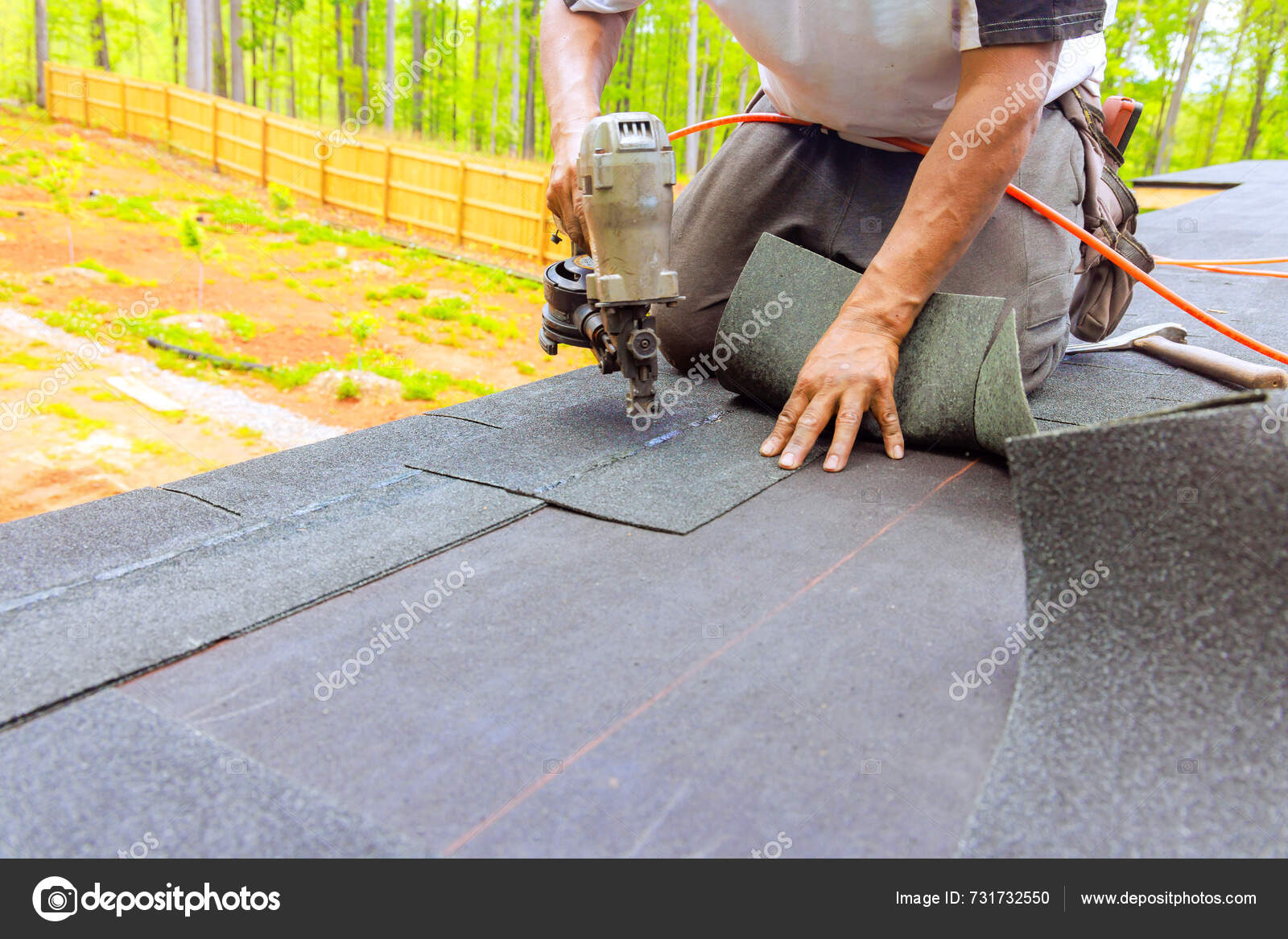 Construction Worker Roofer Installing New Bitumen Shingles Roof Used ...
