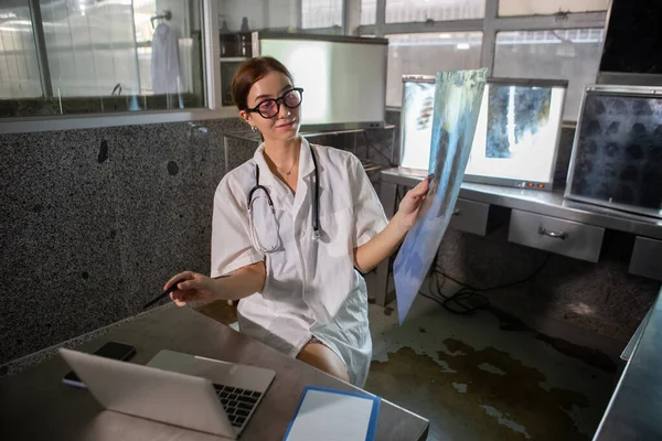 Doctor woman working check up x-ray film in medical laboratory at ...