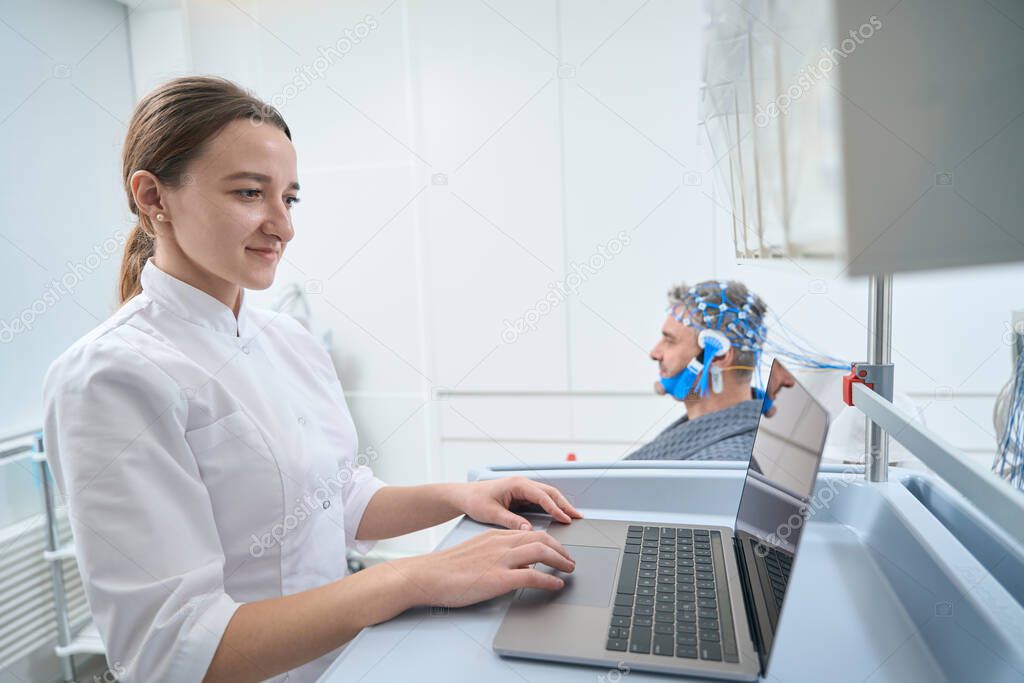 Doctor conducts a diagnostic procedure for EEG - electroencephalography ...