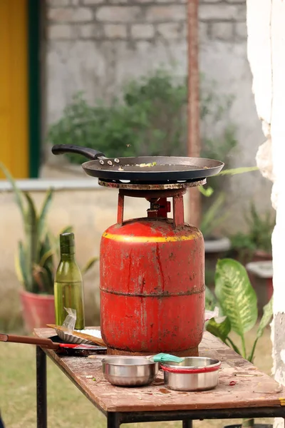 Small propane gas cylinder and heating pad for cooking. Cooking in a ...