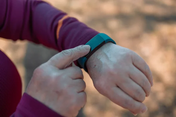 Woman using activity tracker or heart rate monitor. Outdoor fitness ...
