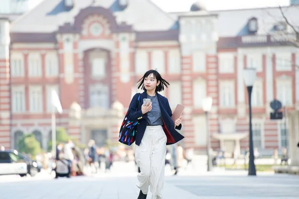 A young woman commuting to work or going out on a fine day - Stock ...