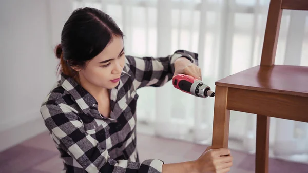 Women Using Screwdriver Installation Screw Assembling New Chair While ...