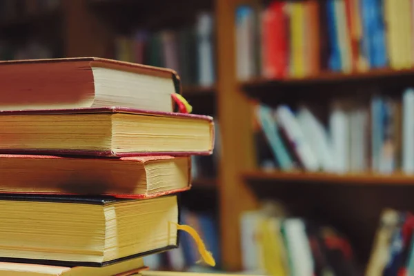 stack of books with a pile of hardback bookshelves in the library ...