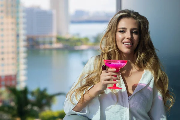 Sensual woman enjoy drink coctail at terrace balcony on summer vacation ...