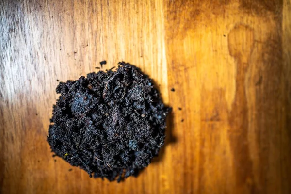 conducting a soil test in a home lab. soil on a table. brown dirt in a ...