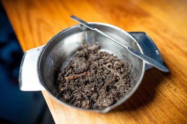 conducting a soil test in a home lab. soil on a table. brown dirt in a ...