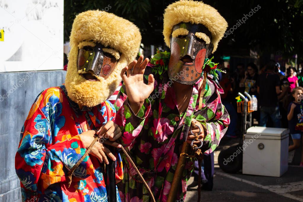 A group of masked people. Typical figures at the Revelry of Kings, a ...