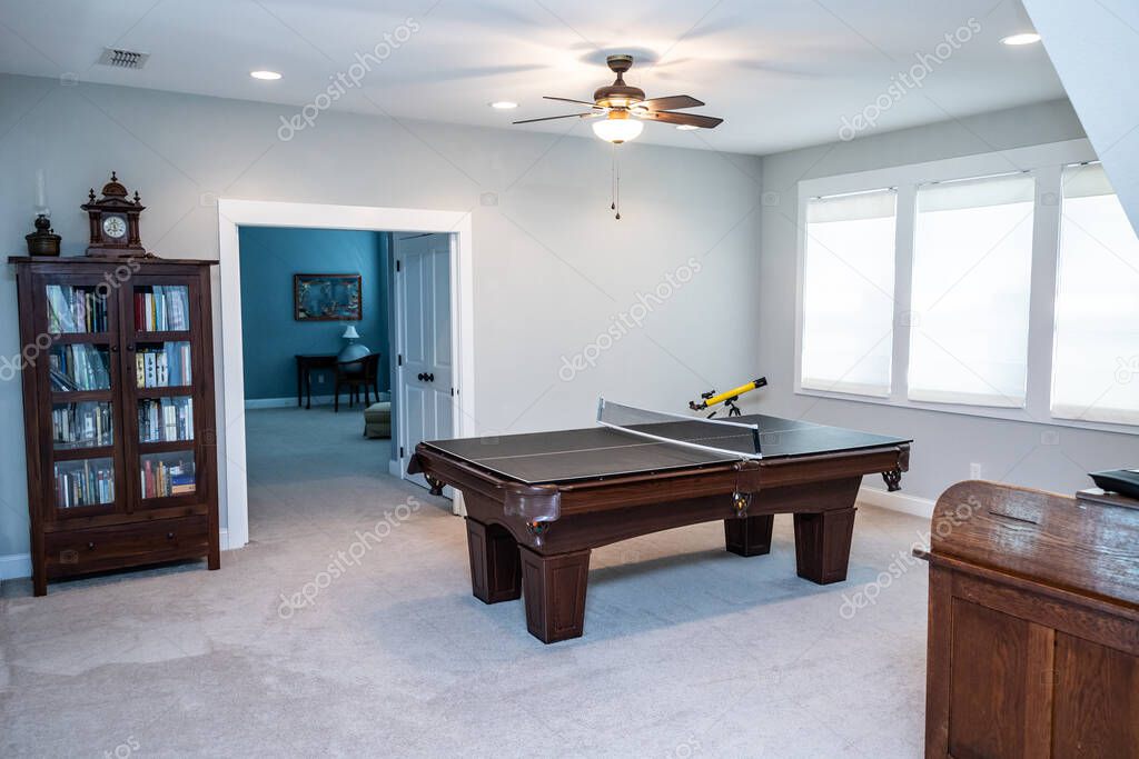 An upstairs loft air used as a bonus game room with a pool table and ...