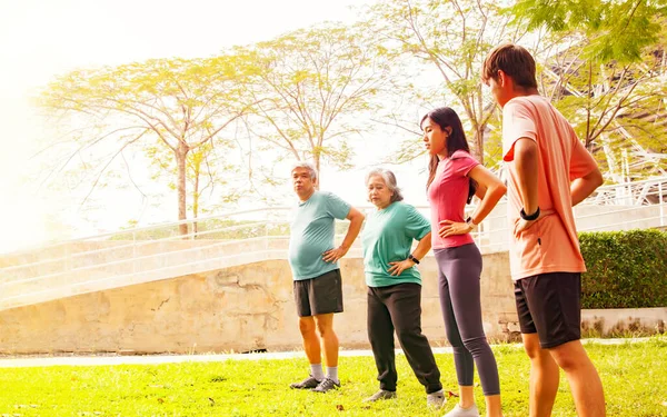 Happy asian family elderly parents and daughter son health care warm up ...