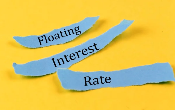 FLOATING INTEREST RATE text on blue pieces of paper on yellow ...