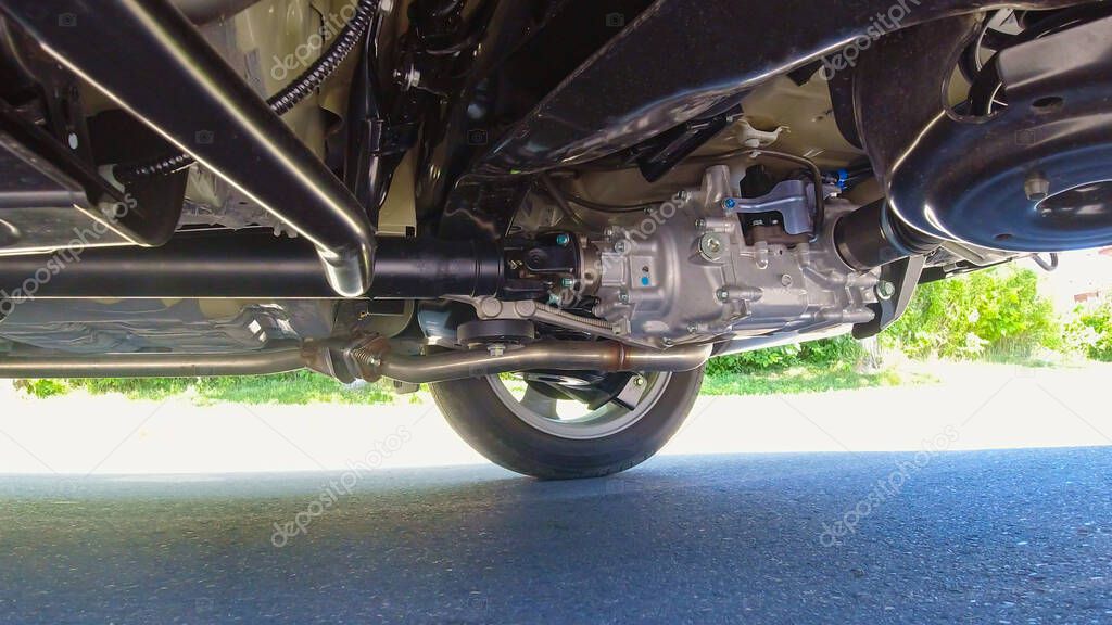 Auto mechanic view of bottom of the car. Rear differential axle wide ...