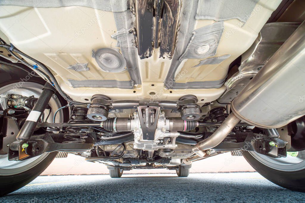 Auto mechanic view of bottom of the car. Rear differential axle wide ...