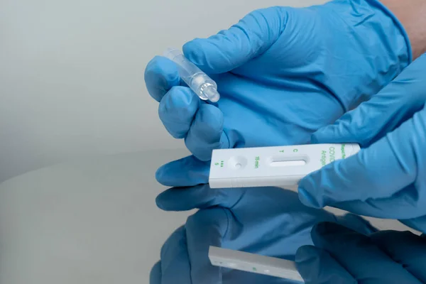 Person drops specimen test liquid in rapid test cassette for detection ...