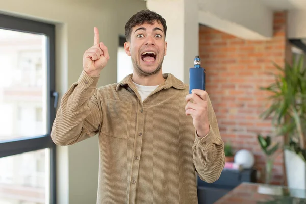 young handsome man feeling like a happy and excited genius after ...