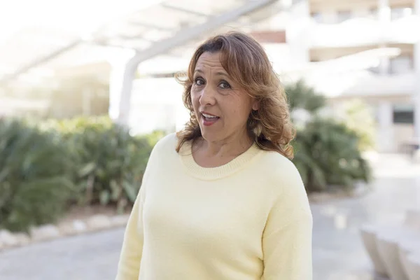 middle age woman with a big, friendly, carefree smile, looking positive ...