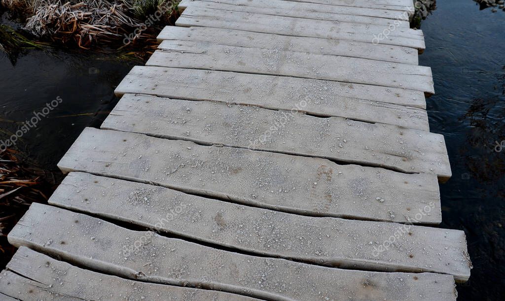 floating walkway made of wooden planks, pier, narrow curved paths on ...